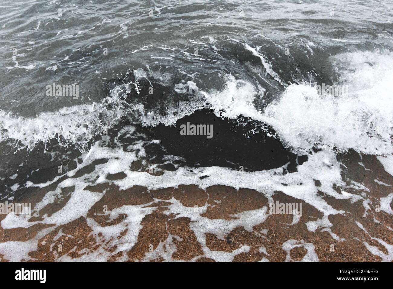 Blue seawater and sandy shore Stock Photo - Alamy