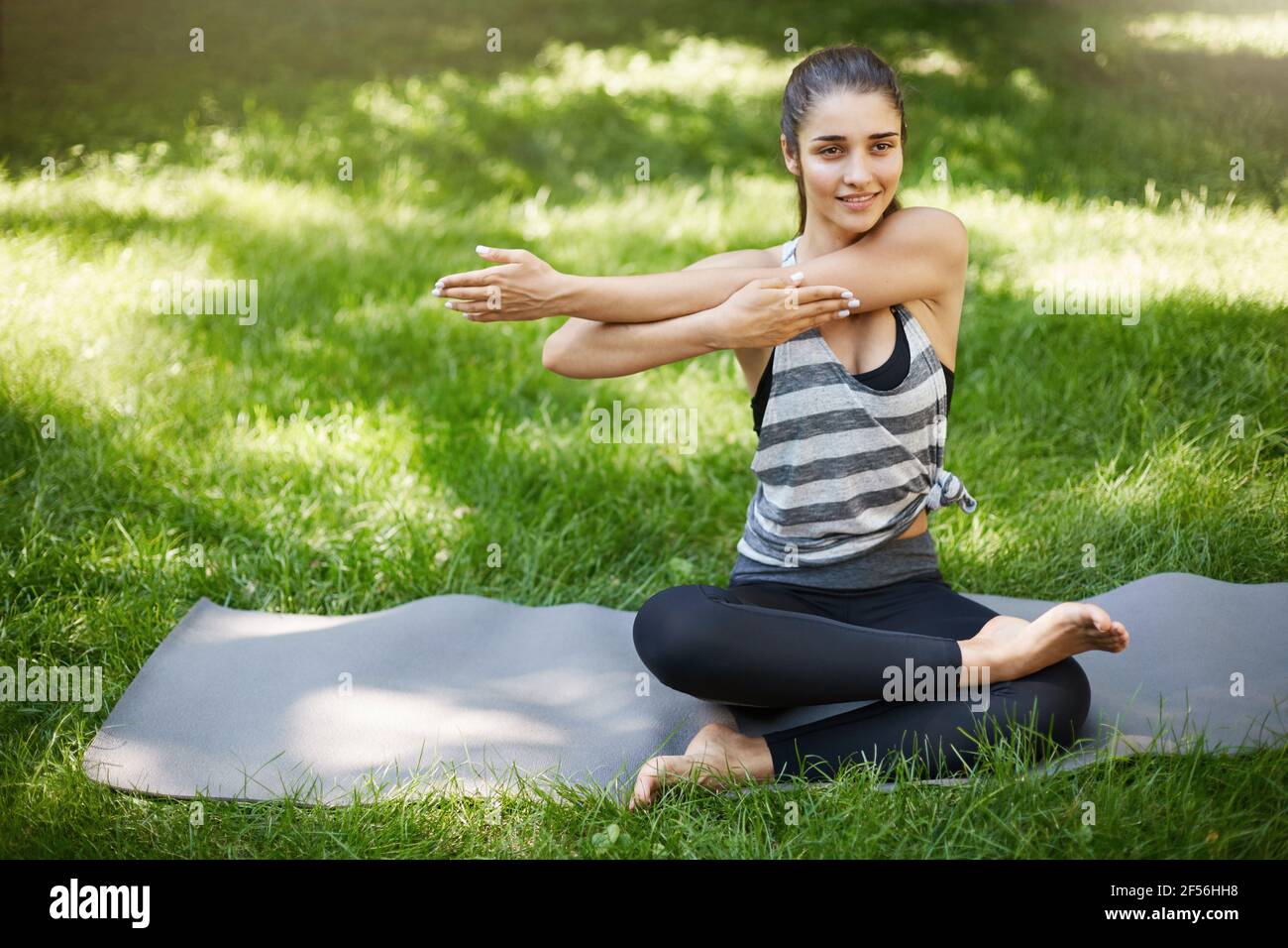 Beautiful female stretching taking long breath excercising her muscles ...