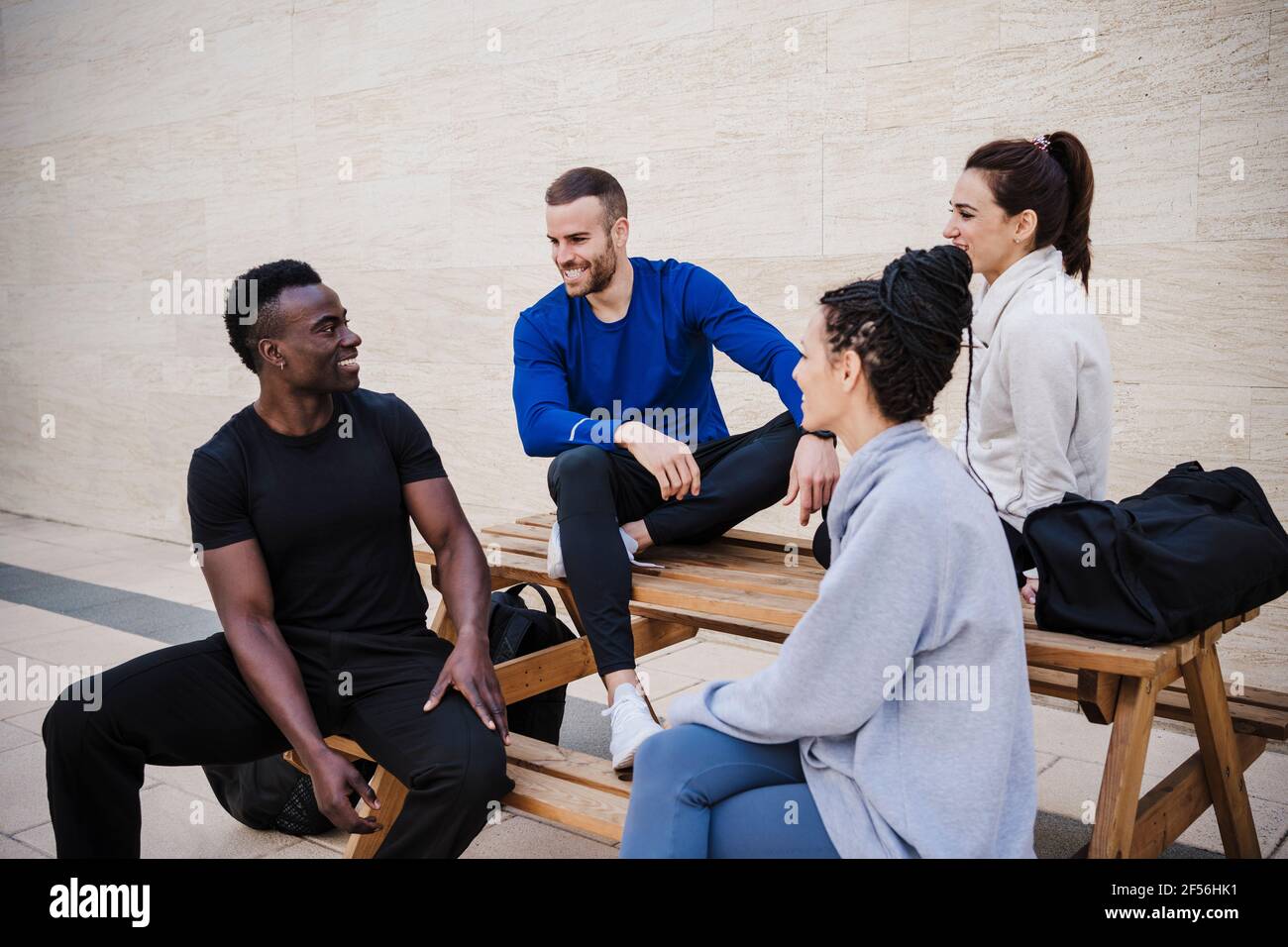 Four women sitting on the bench hi-res stock photography and images - Alamy