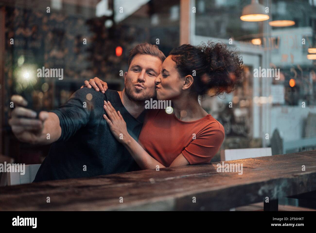 Woman kissing mobile phone hi-res stock photography and images - Alamy
