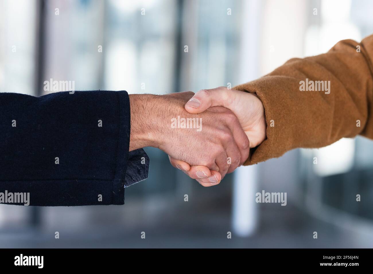 Business partners shaking hands outdoors Stock Photo - Alamy