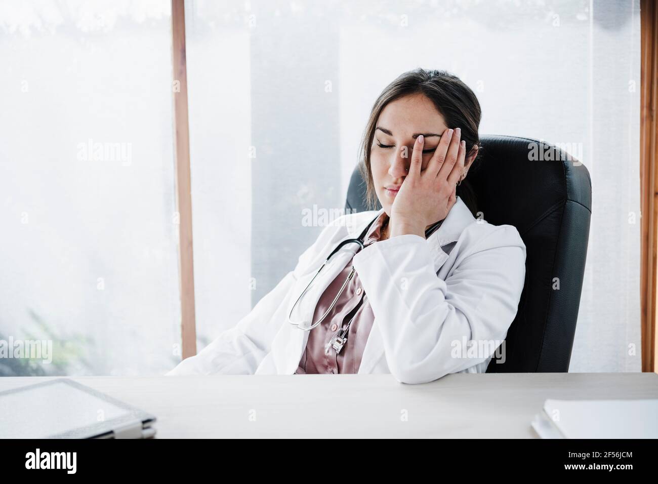 Eyes closed woman doctor hi-res stock photography and images - Alamy