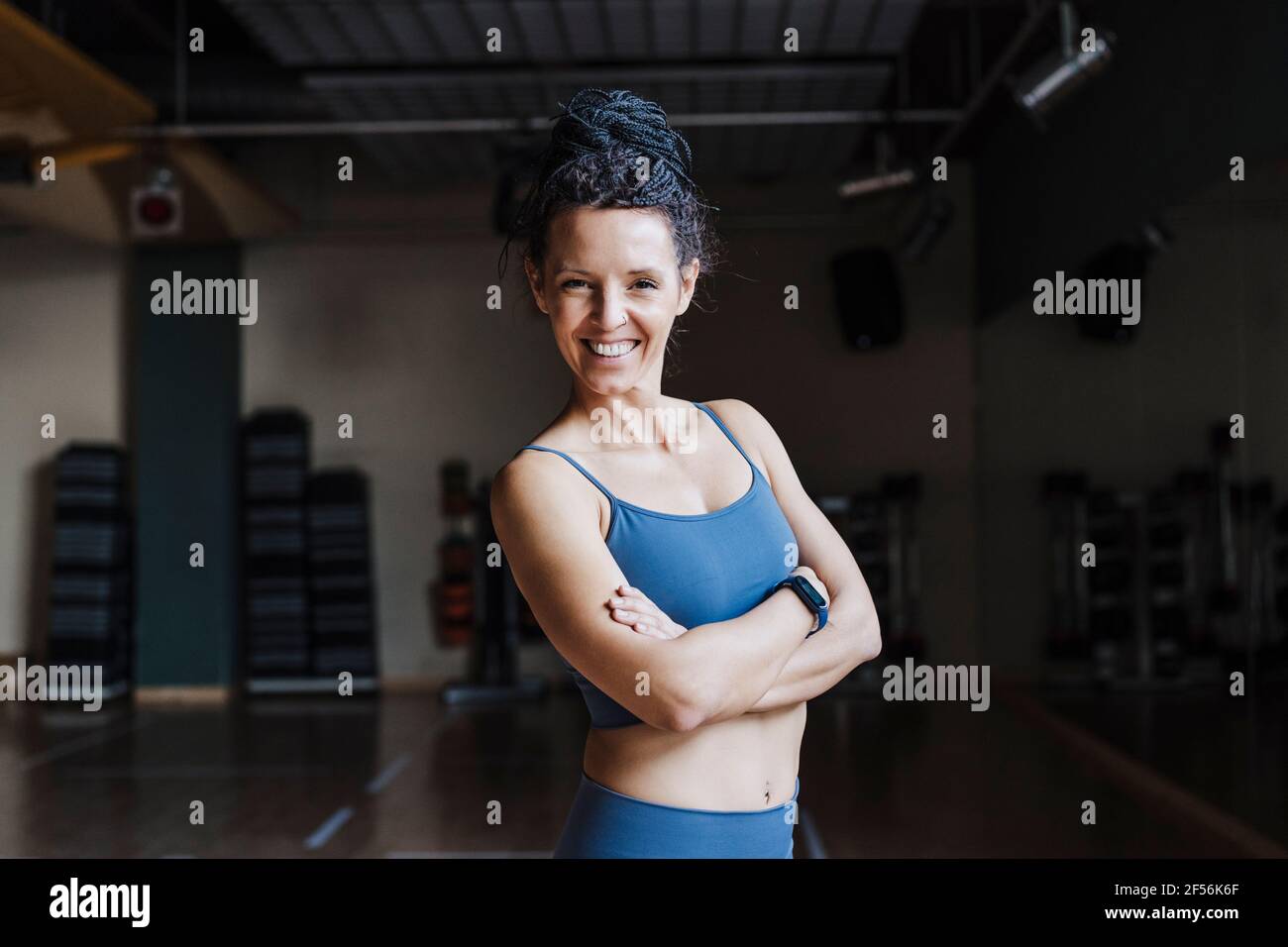 Cheerful female sportsperson with arms crossed in gym Stock Photo - Alamy