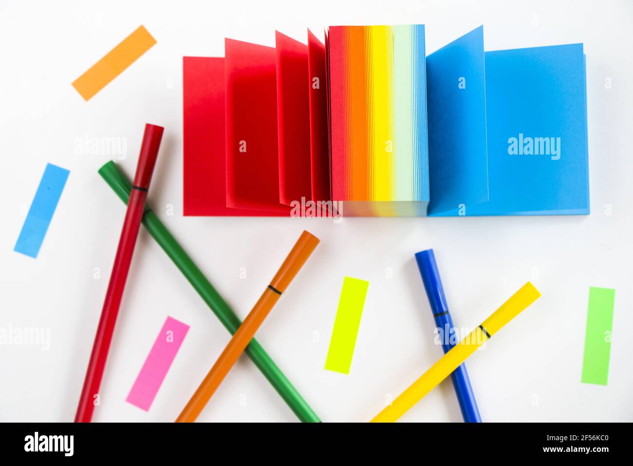 Overhead shot of a set of sketch markers with a colorful notepad with ...