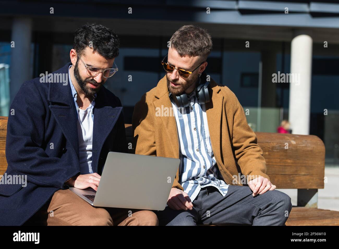 Business partners using laptop hi-res stock photography and images - Alamy