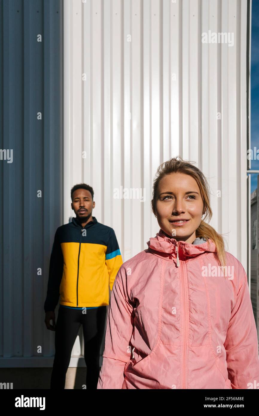 Male and female sportsperson standing against wall Stock Photo - Alamy