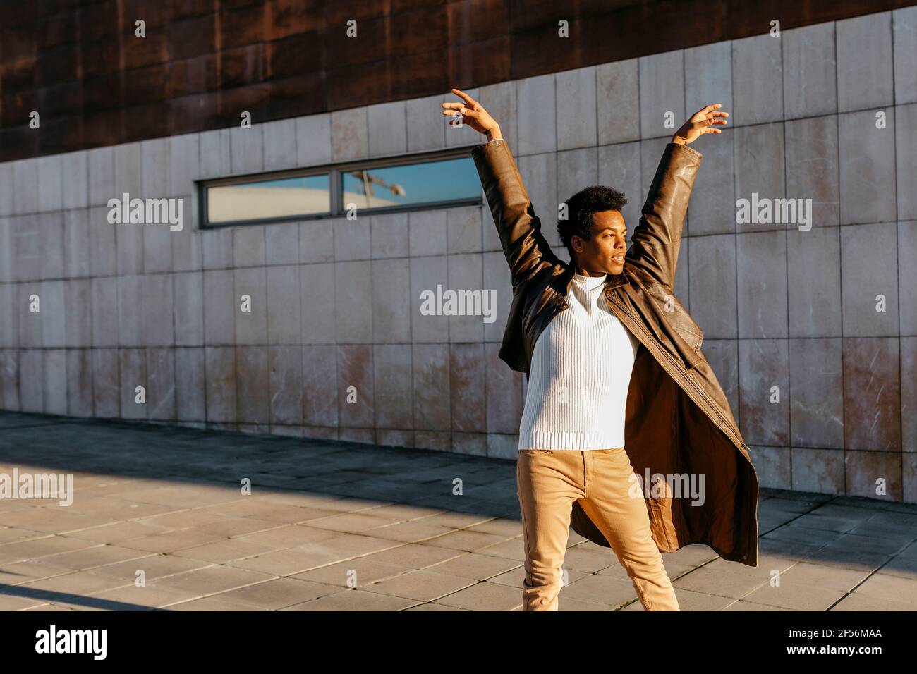 Smiling man dancing raising arms hi-res stock photography and images ...