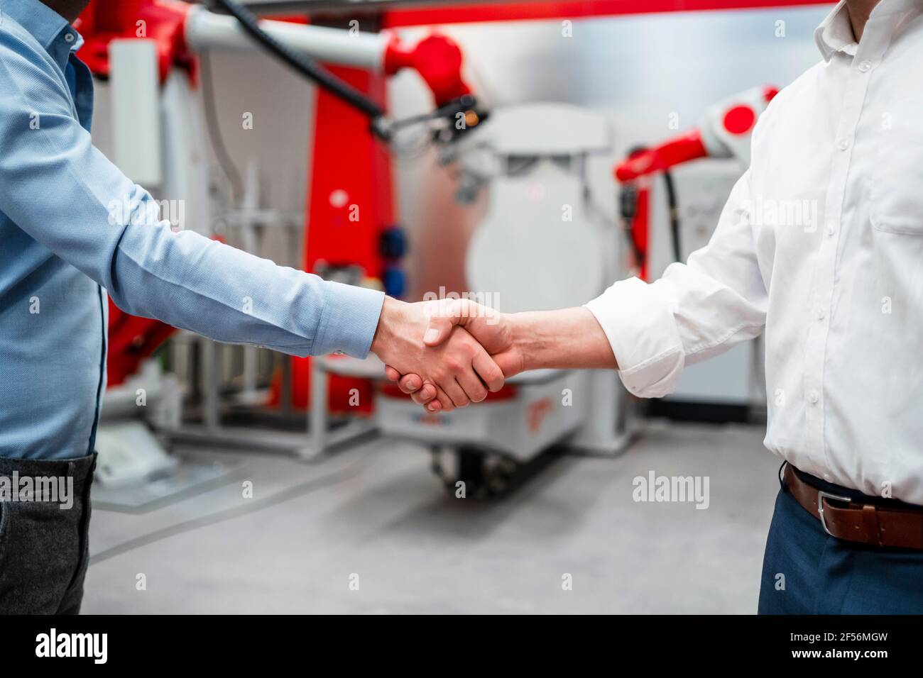 Men shaking hands on building hi-res stock photography and images - Alamy