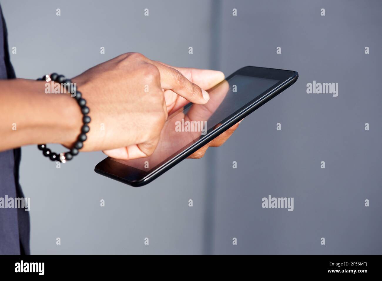Side portrait of young black man hands using digital tablet Stock Photo ...