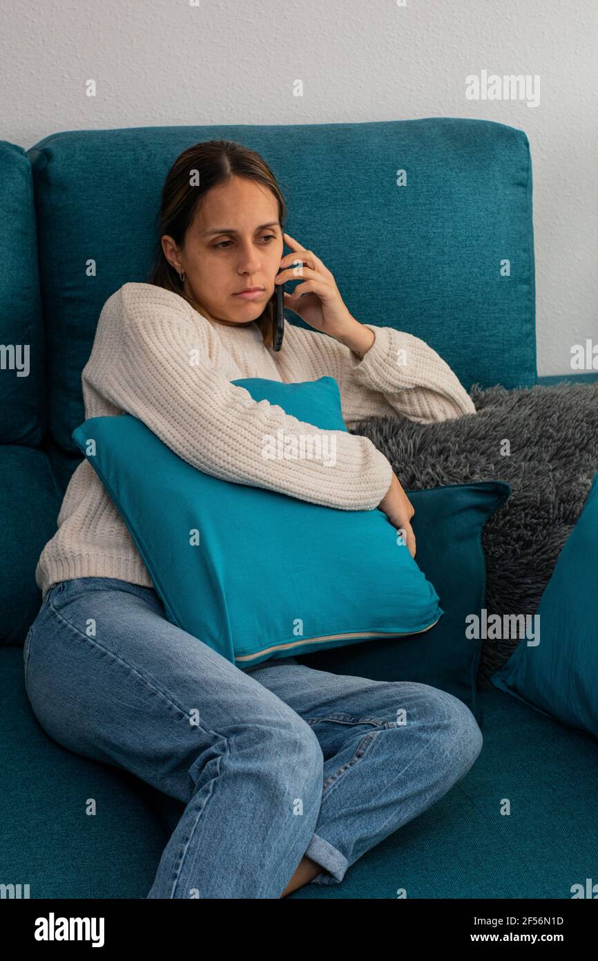 Girl talking on her mobile phone, which she holds against her ear with ...