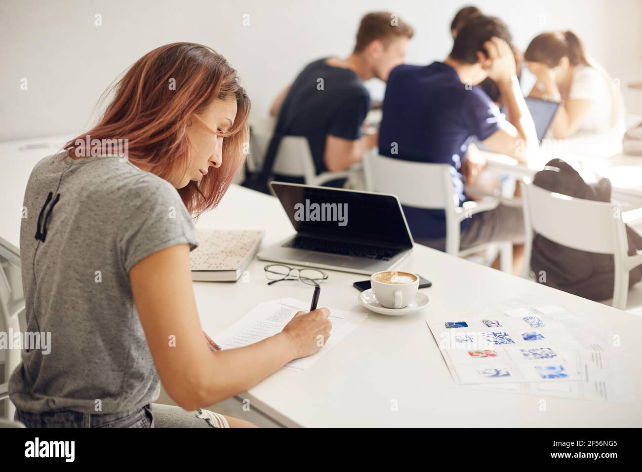 Interior design student filling out forms working in a campus or a ...