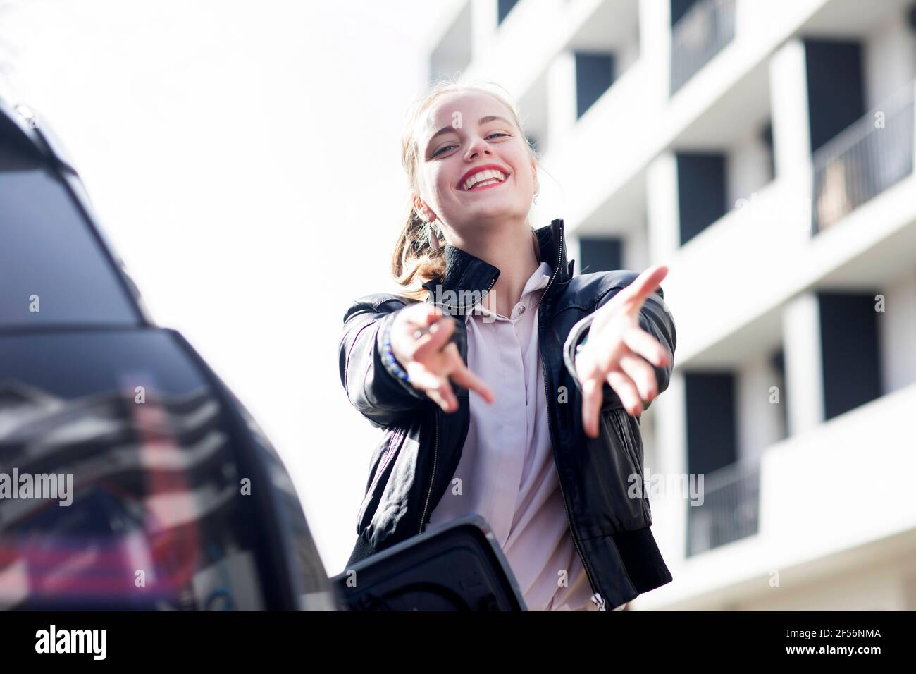 Portrait of young beautiful blonde reaching toward camera Stock Photo ...