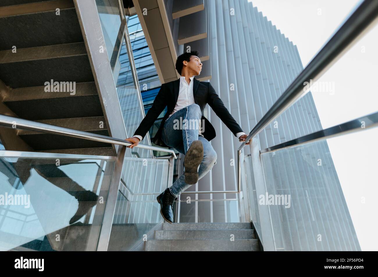 Male professional dancing on staircase while looking away Stock Photo ...