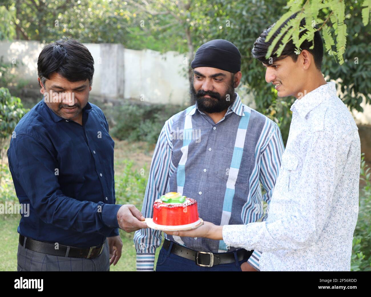 Closeup shot of three Indian men celebrating a birthday party with a ...