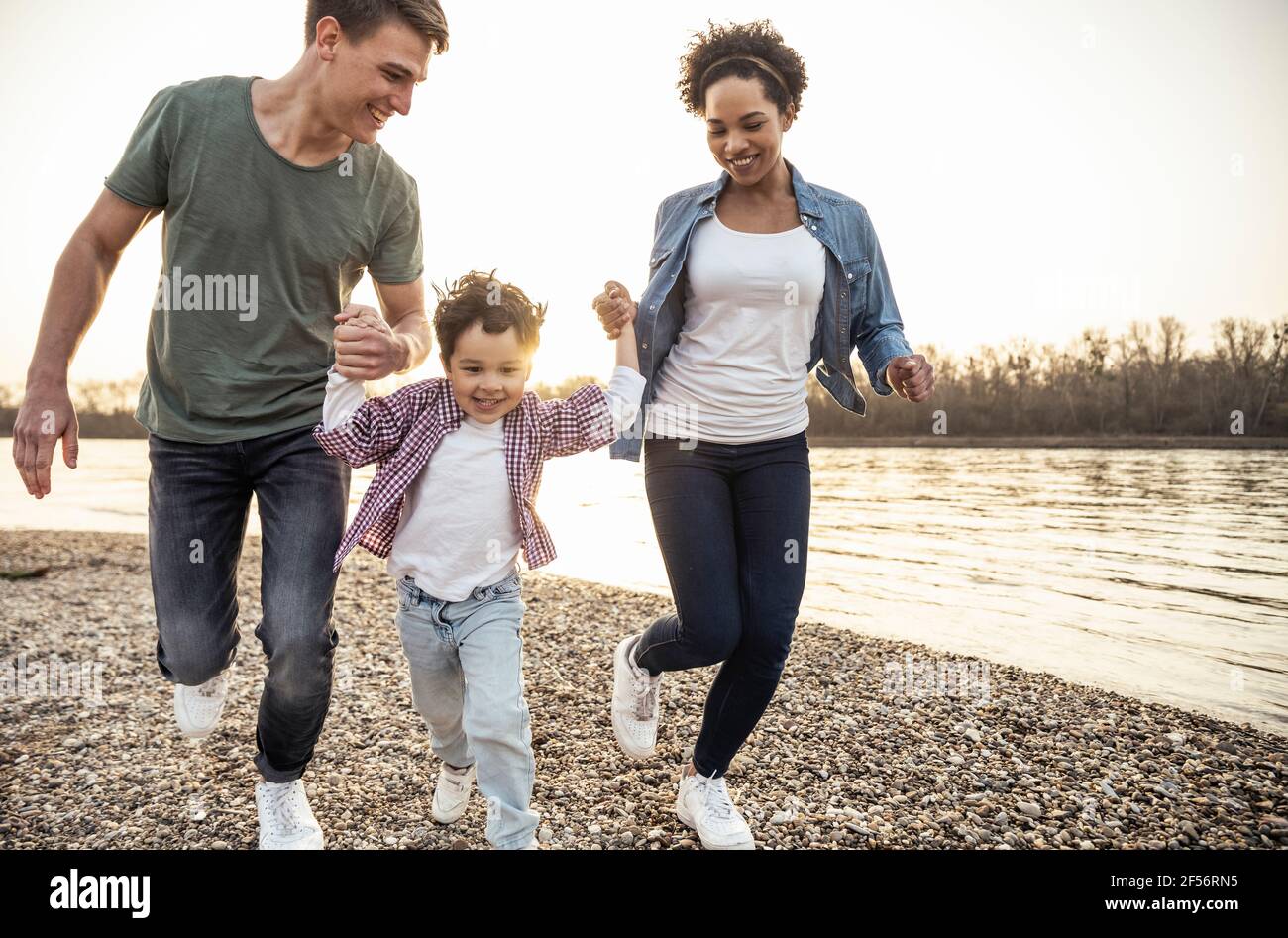 Parents running hand hand hi-res stock photography and images - Alamy