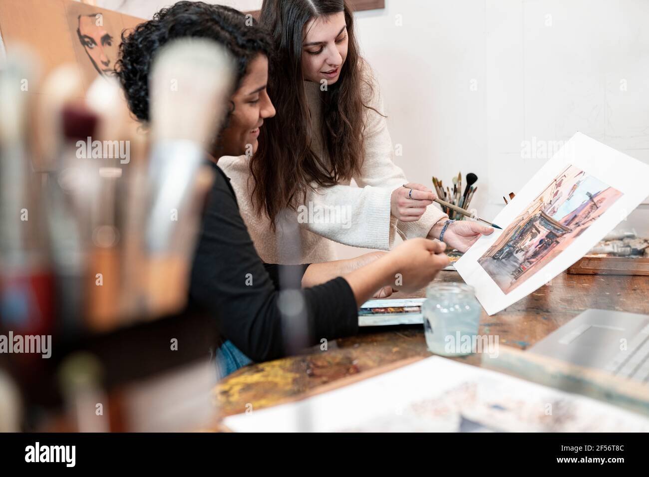 Female painter holding paintbrush over hi-res stock photography and ...