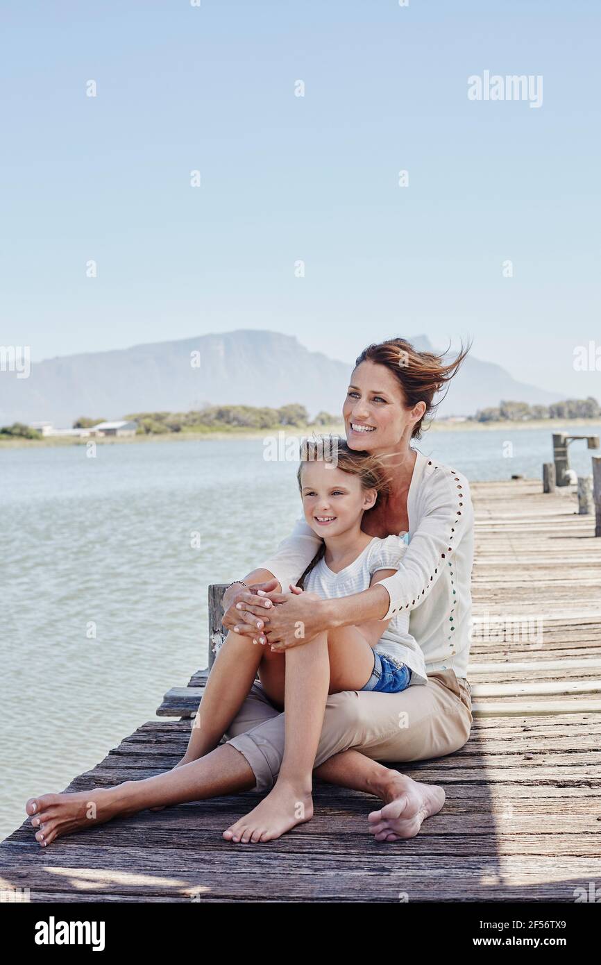 Children sitting on pier hi-res stock photography and images - Alamy