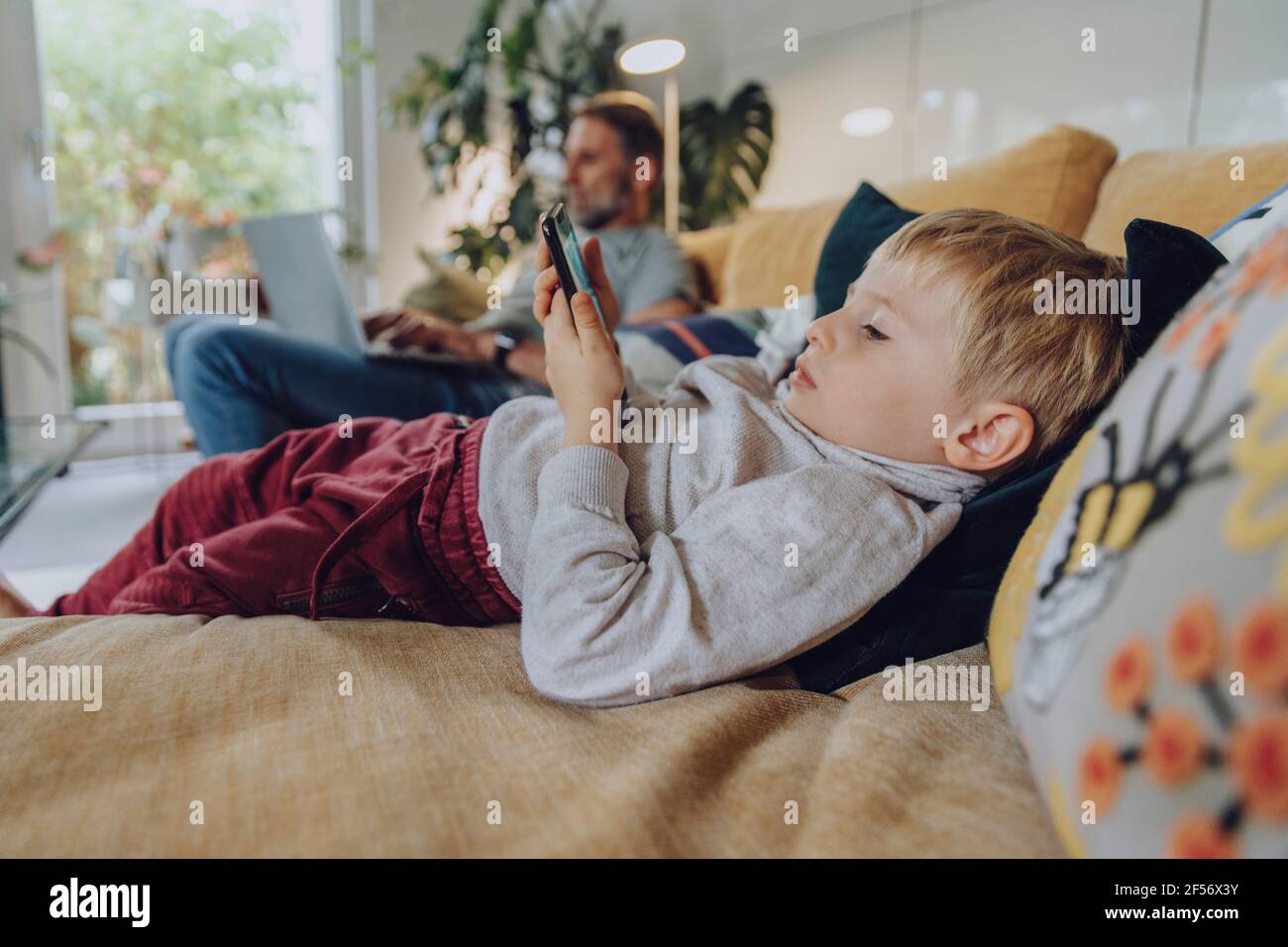 Boy lying with phone hi-res stock photography and images - Alamy
