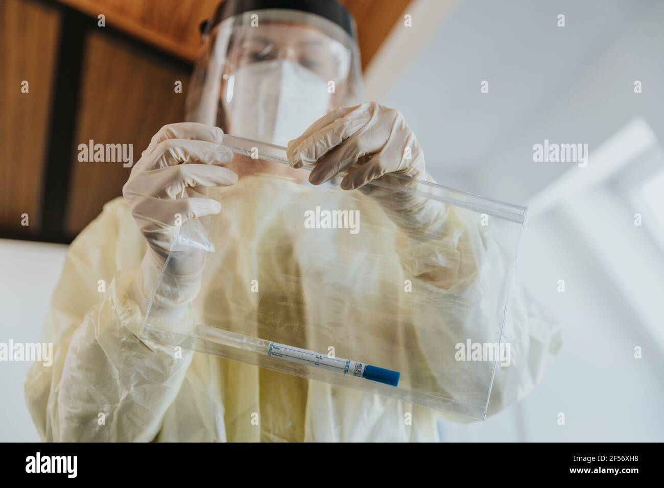 Expertise wearing protective suit collecting nasal swab test tube in ...
