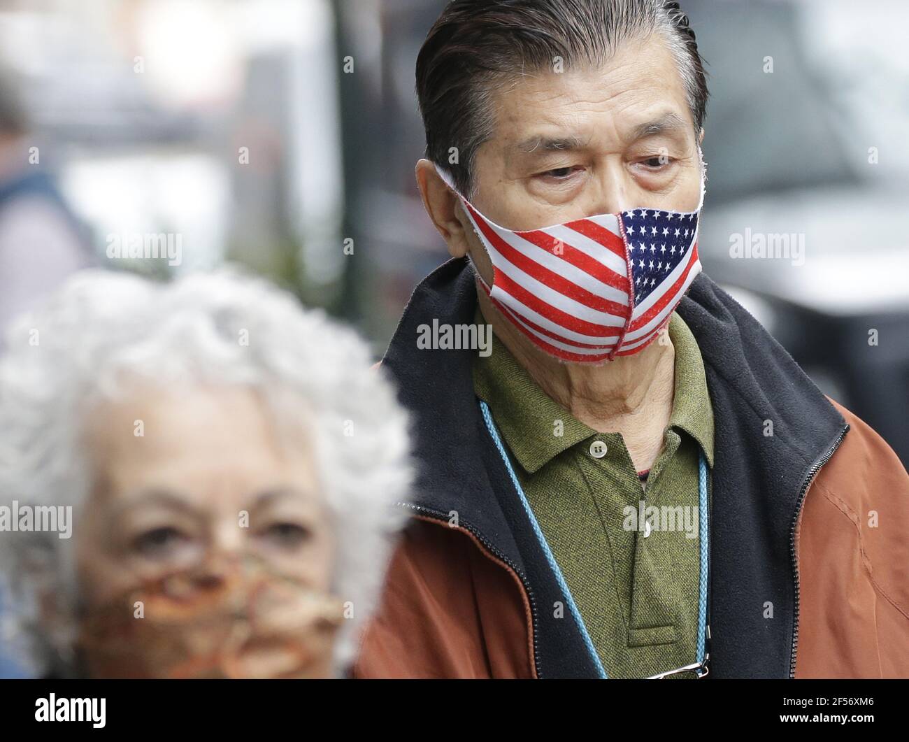 New York, United States. 24th Mar, 2021. A pedestrian wears a face mask ...
