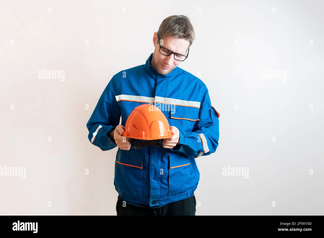 a young male worker holding a helmet, industrial safety equipment Stock ...
