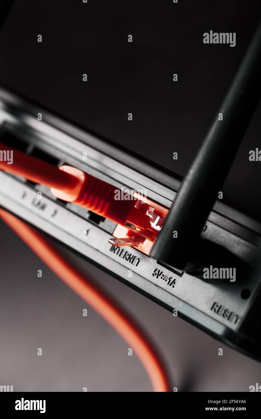 The red patch cord is inserted into the router's Wi-Fi port to access ...
