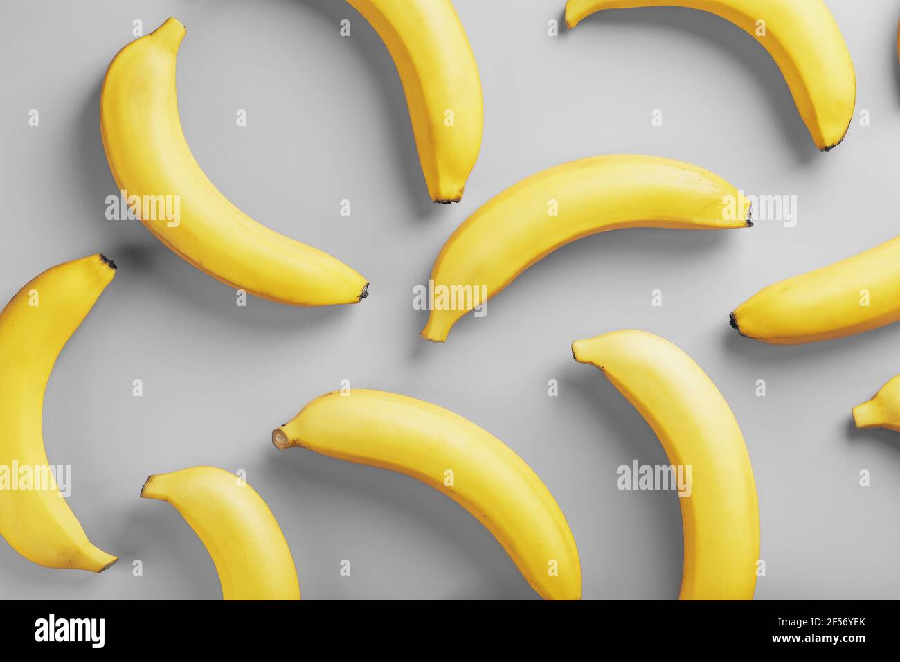 Geometric pattern of bananas on a gray background. The view from the ...