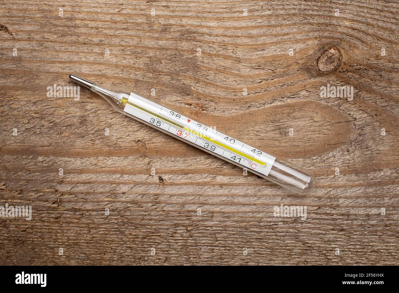 Medical mercury thermometer with a temperature of 37 degrees on a ...