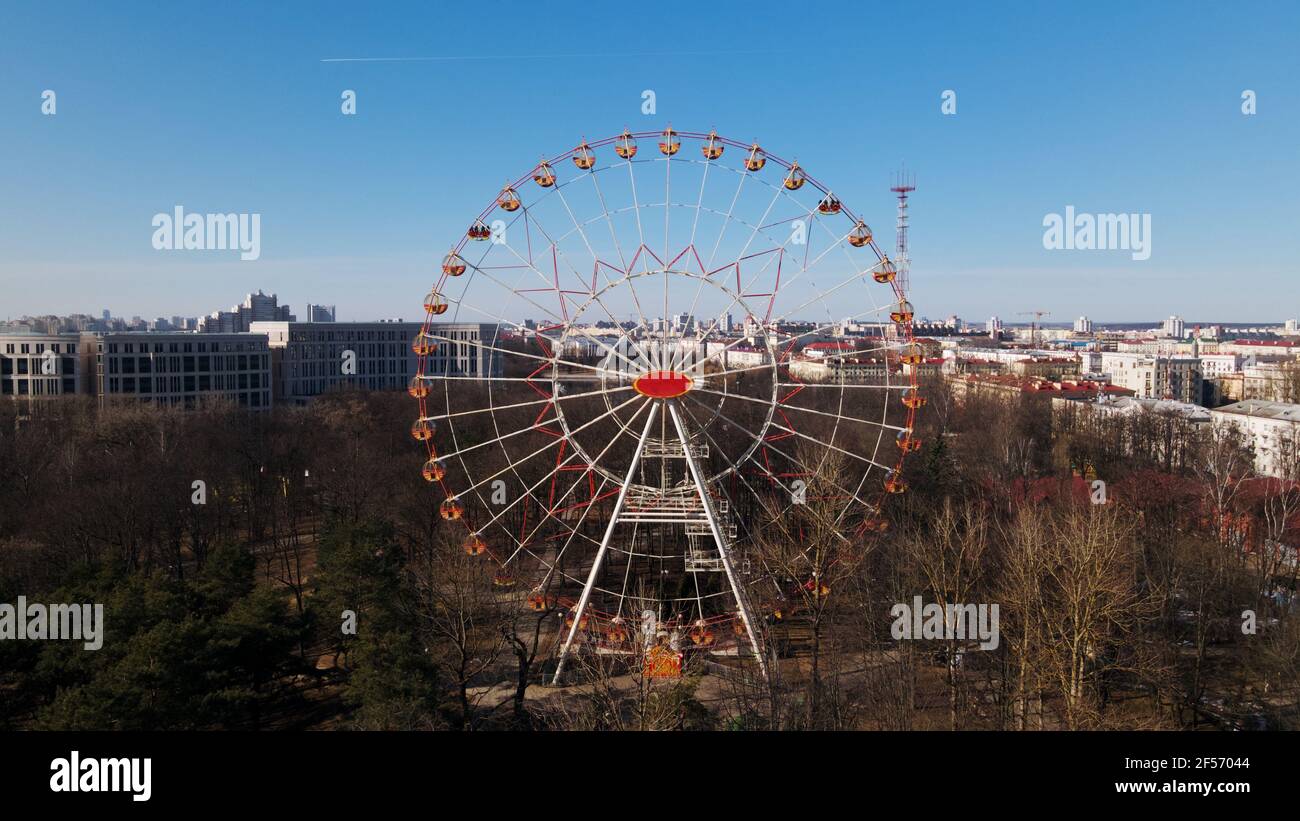 A panoramic shot of a spring city park. The Ferris wheel is visible ...