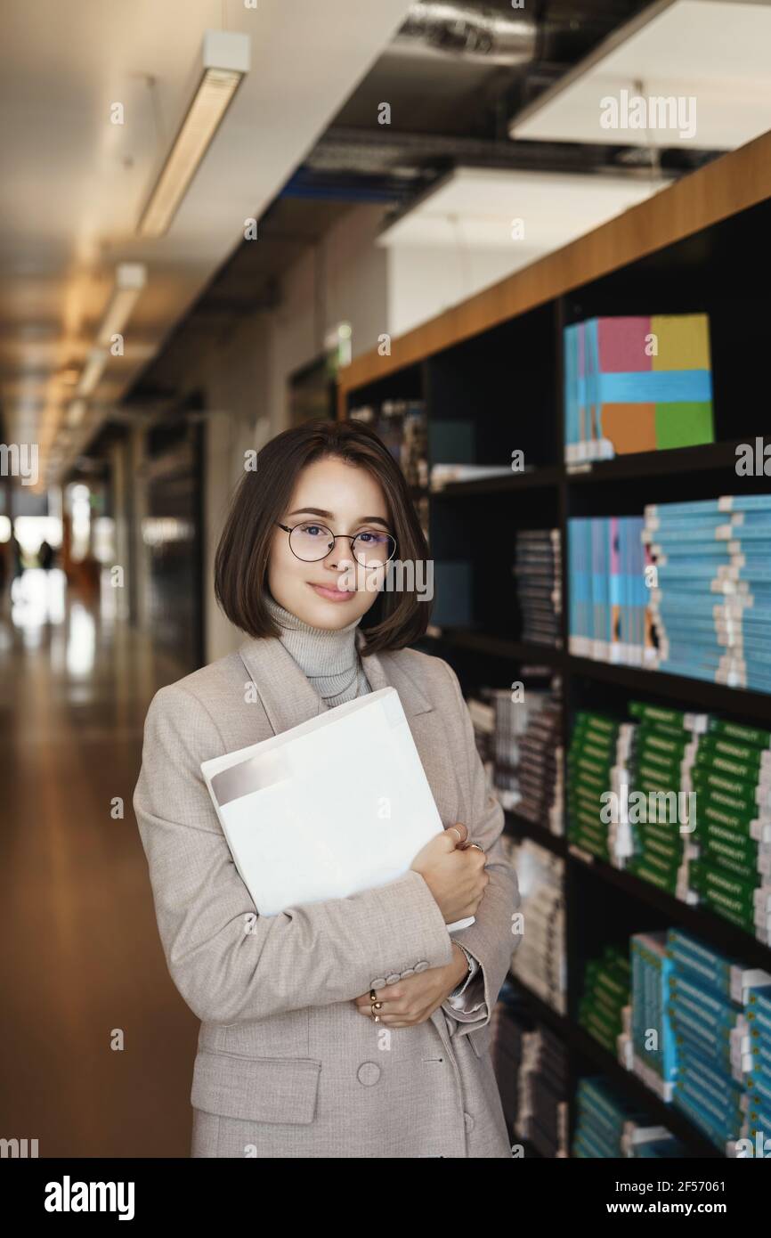 Vertical portrait of smart, good-looking woman, female tutor or teacher ...