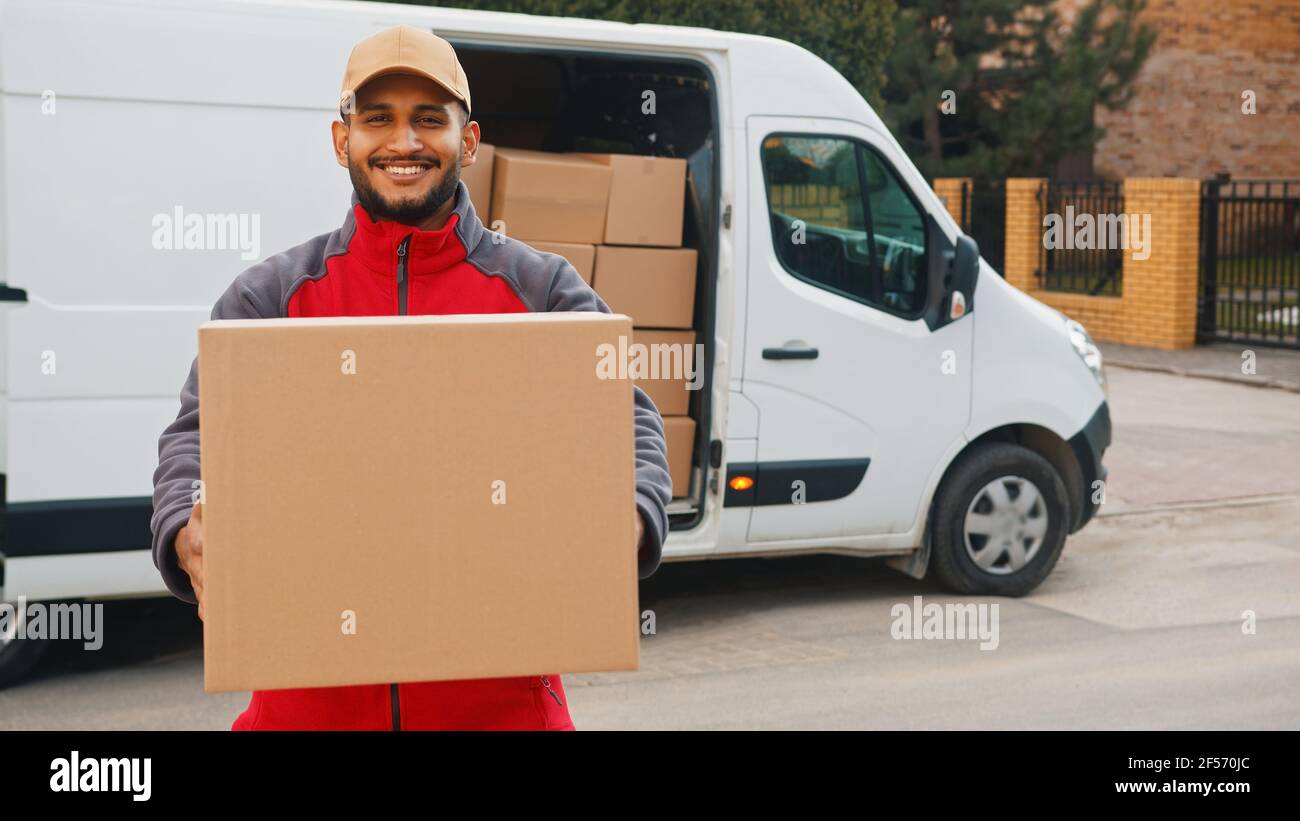 Indian delivery man holding parcel hi-res stock photography and images ...