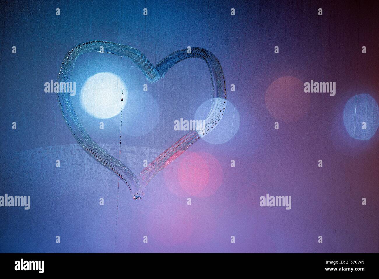 heart symbol hand drawn on wet night window glass in blue colors Stock ...