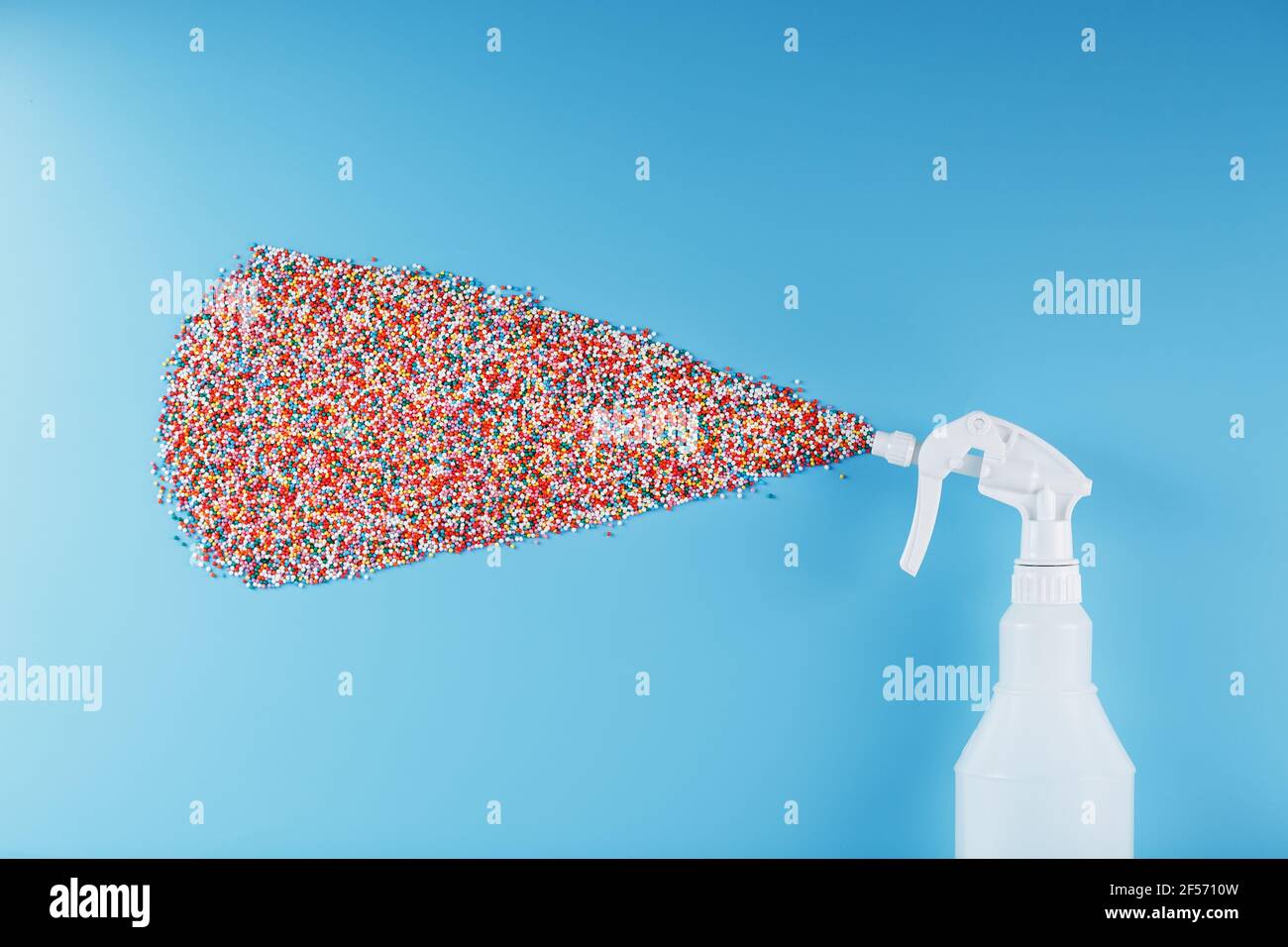 Multi-colored spray balls on a blue background with free space. Isolate ...