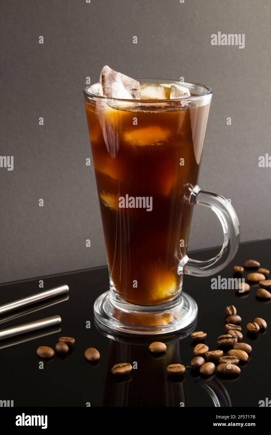 Cold brew coffee in the drinking glass on the black background ...