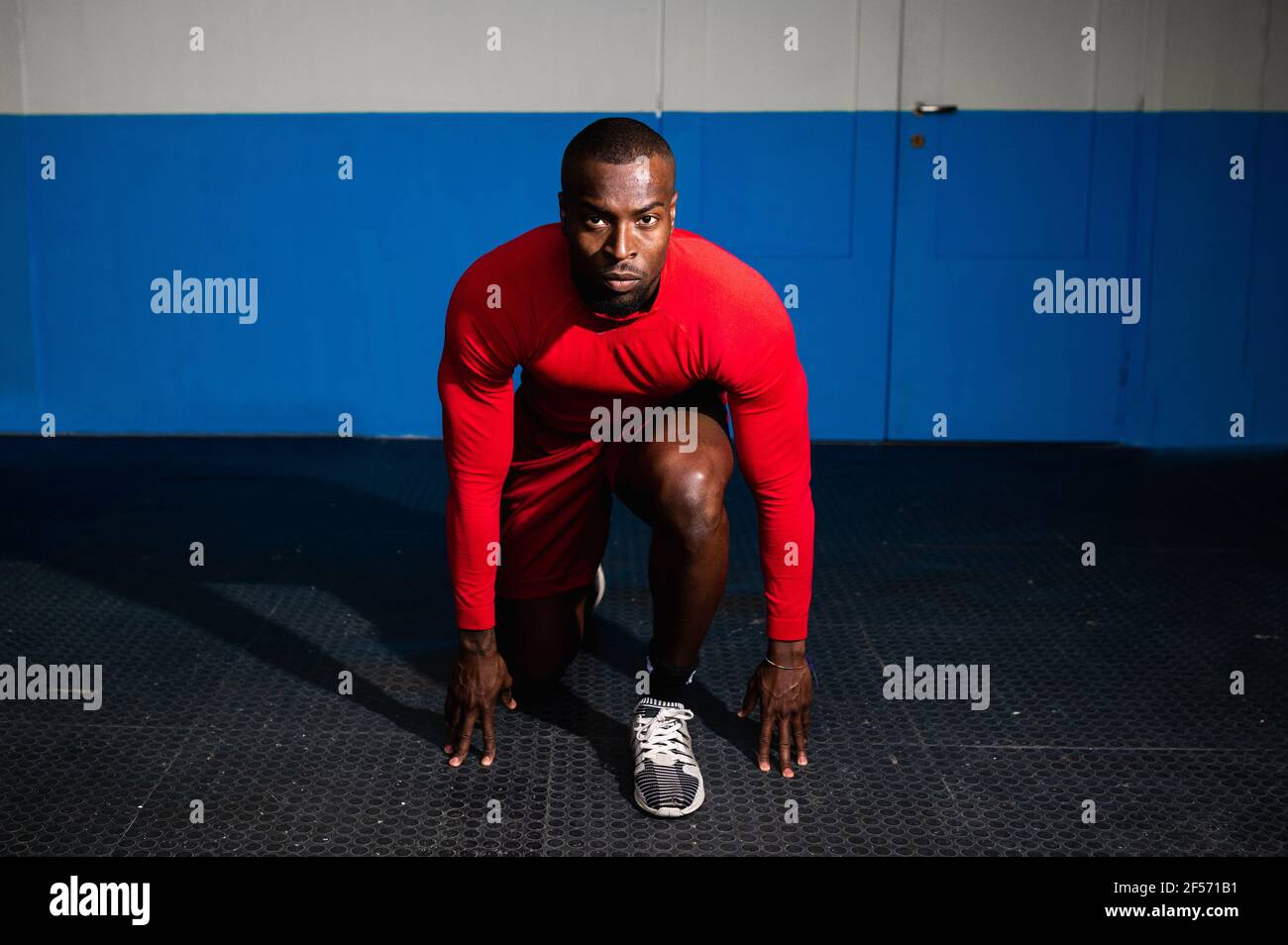 Athletic black man prepare to start running in a match or competition ...