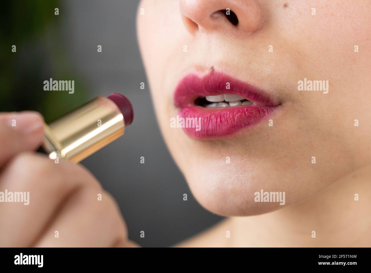 unrecognized woman with lipstick showing her red lips Stock Photo - Alamy