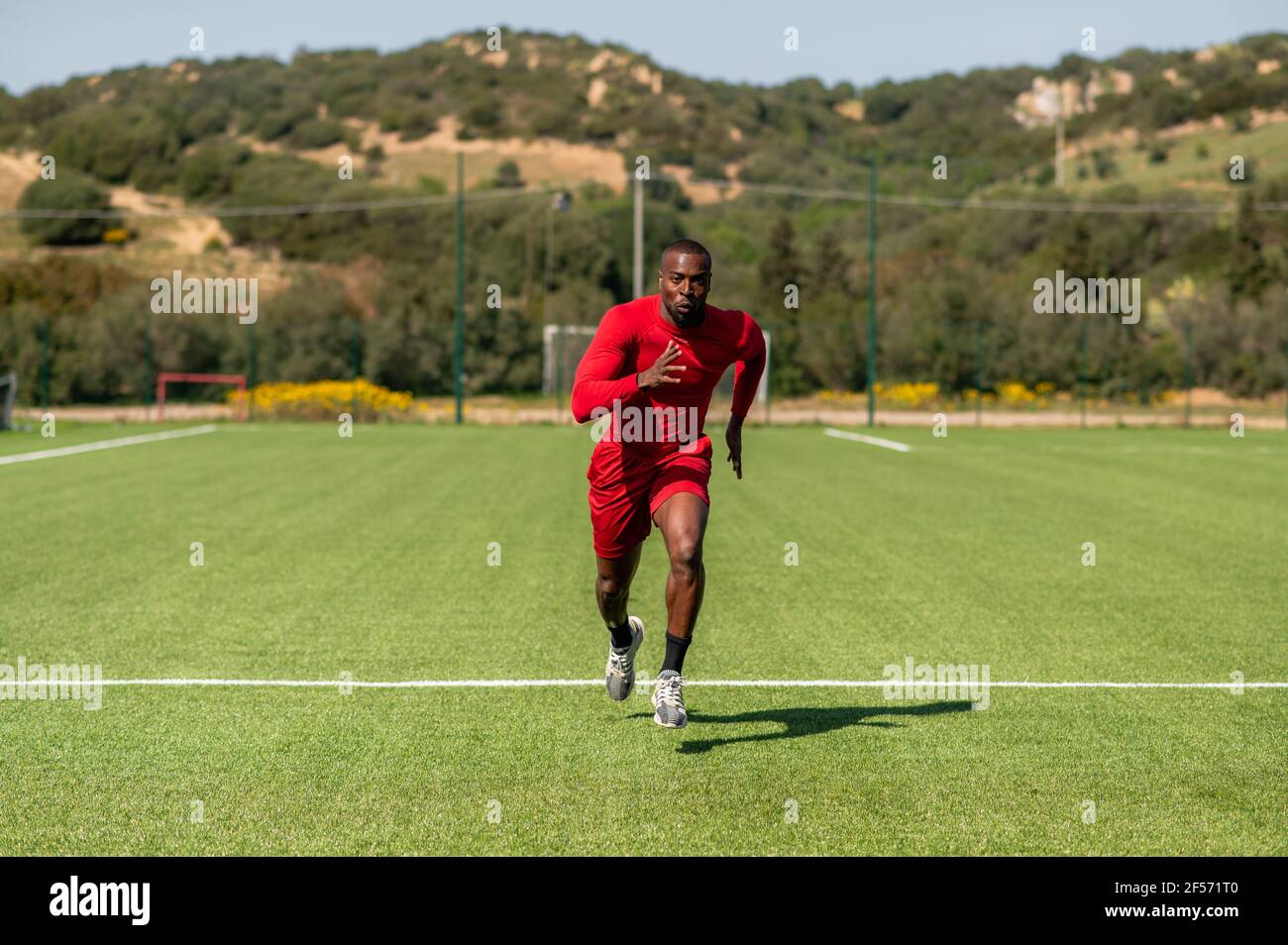 Black sportive speed runner, running in a football field Stock Photo ...