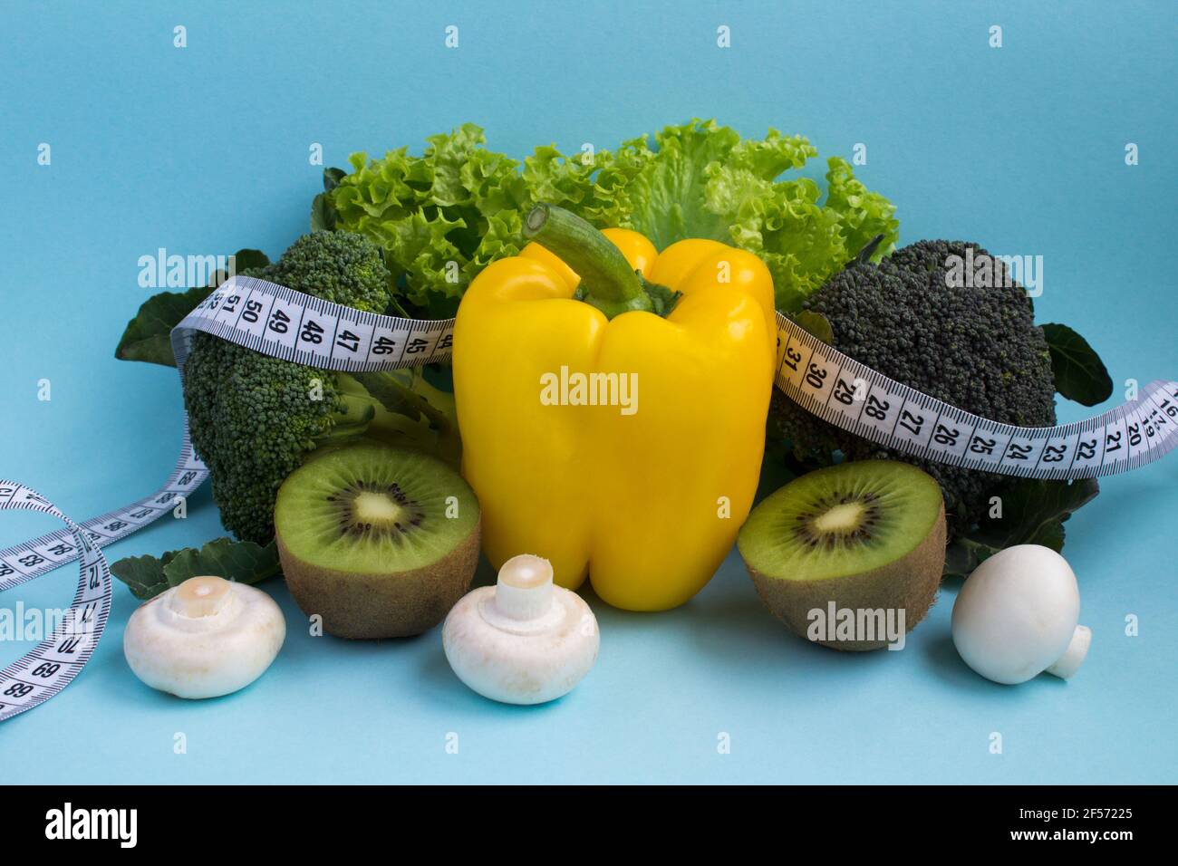 Vegetables,fruits and white centimeter on the blue background.Healthy ...