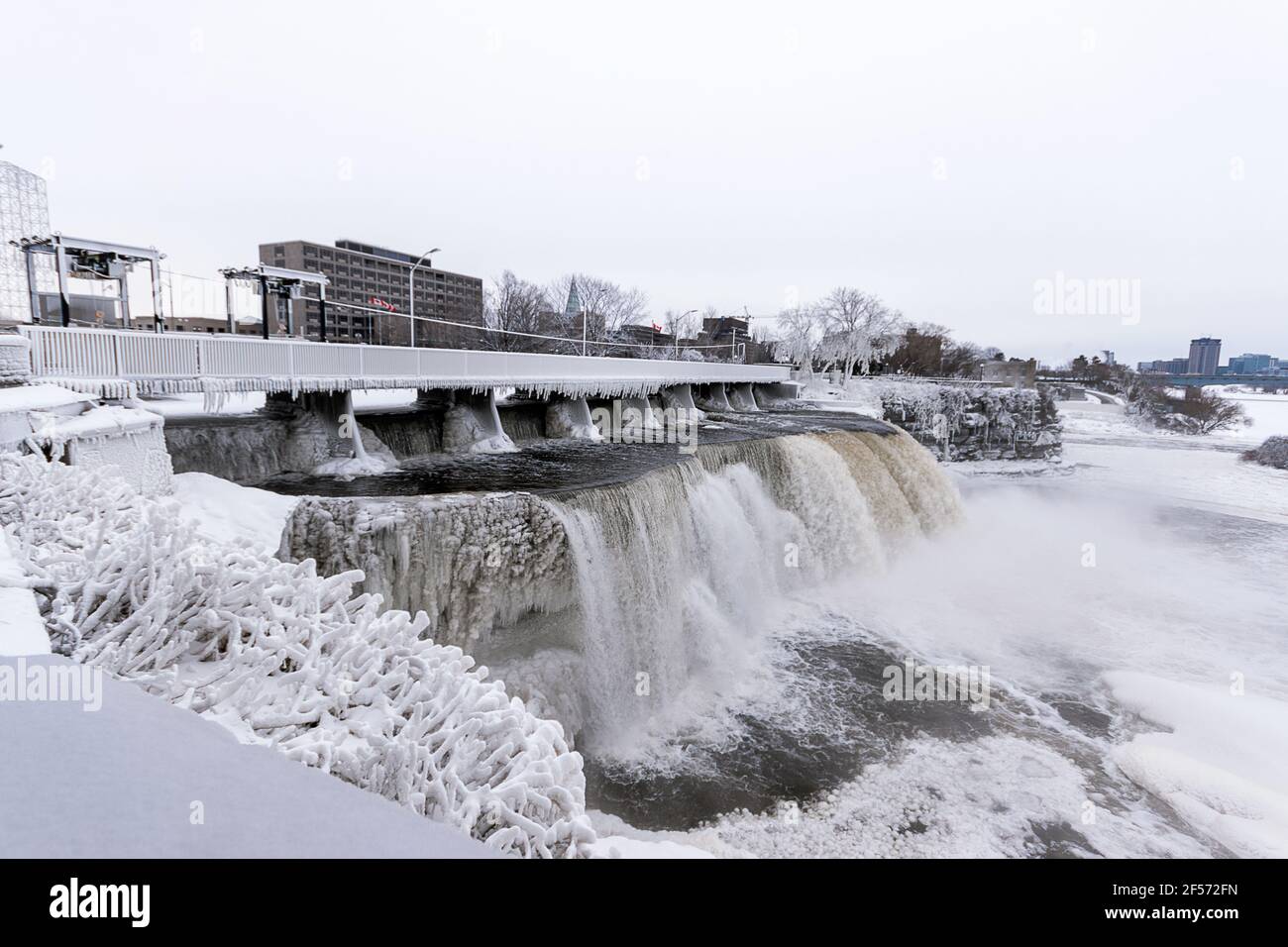 Water coming waterfalls with snow and ice covered plants Stock Photo ...
