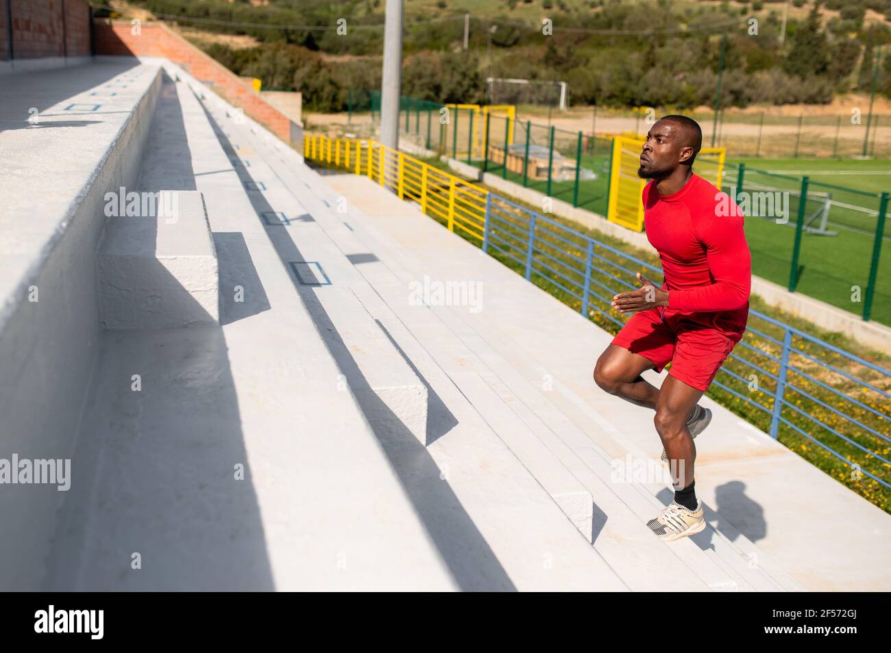 Side view black athletic man running up and down the stairs Stock Photo ...