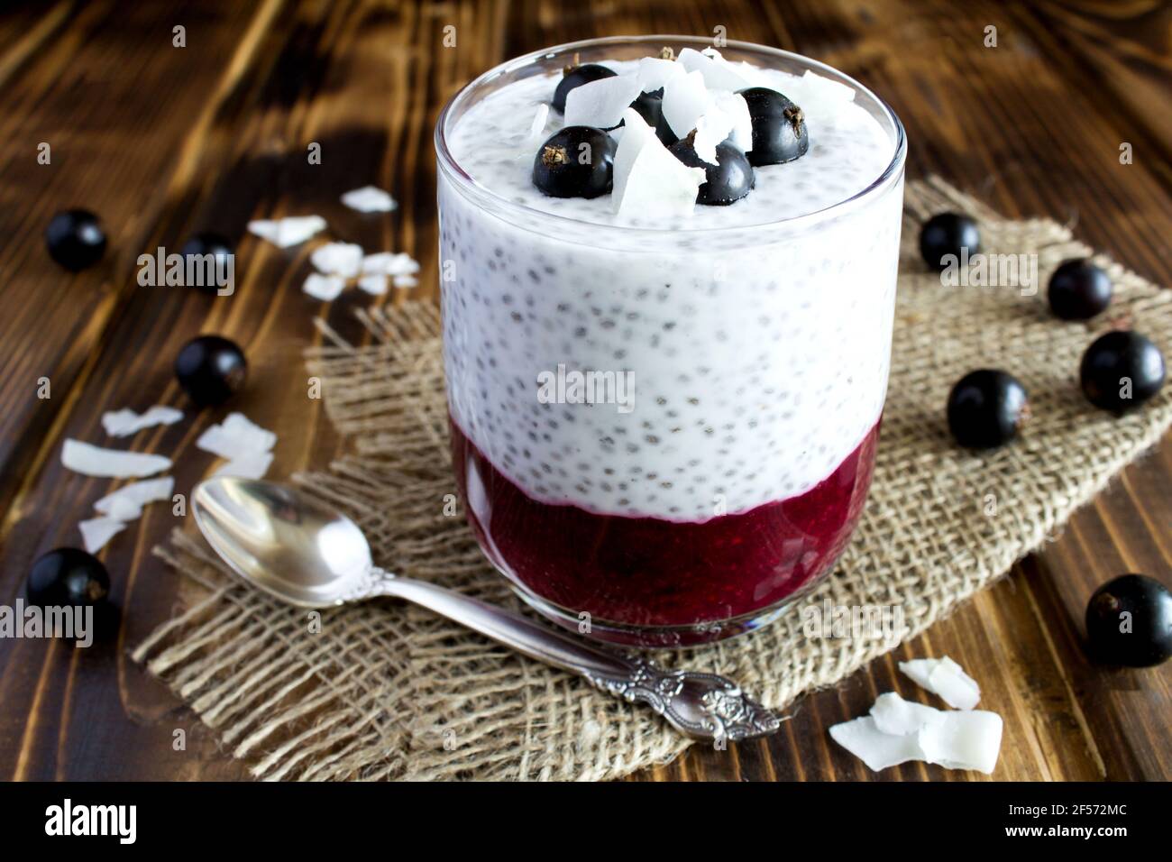Pudding with chia and black currant on the rustic wooden background ...
