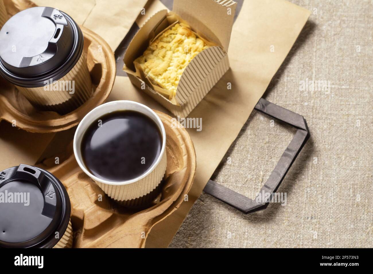 Disposable paper tableware. Coffee cups in the holder, cardboard ...
