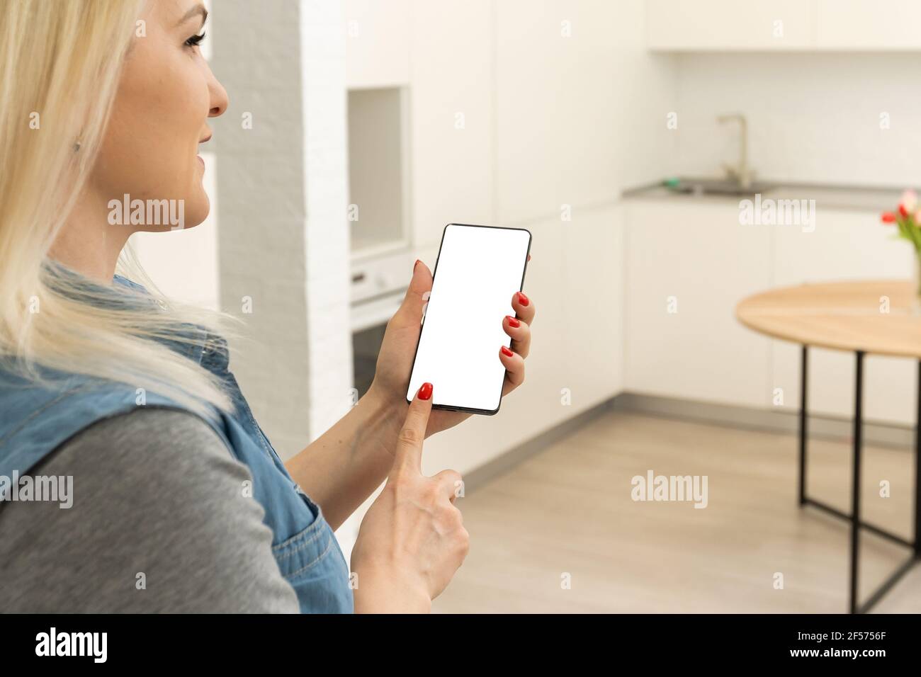 Woman using smartohone in smart house, empty screen Stock Photo - Alamy