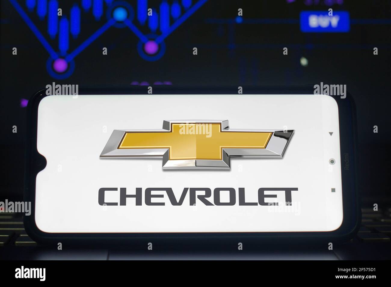 In this photo illustration a Chevrolet logo seen displayed on a ...