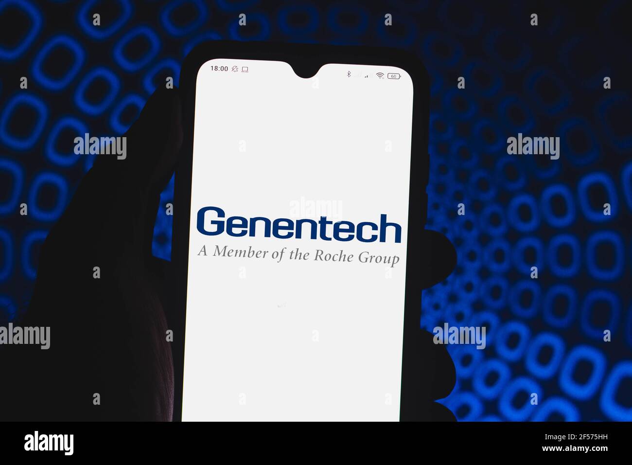 In this photo illustration a Genentech logo seen displayed on a ...