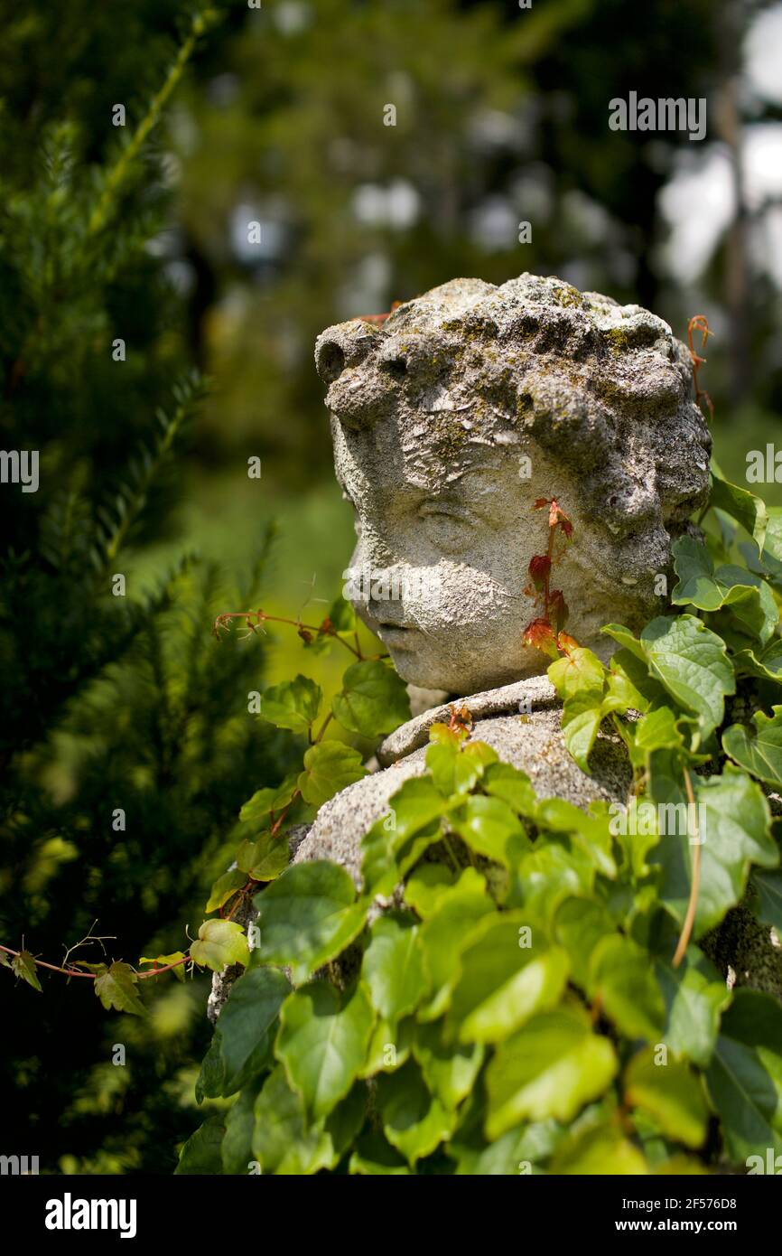 Moss covered statues at Greenwood Gardens in Millburn, NJ, USA. These ...