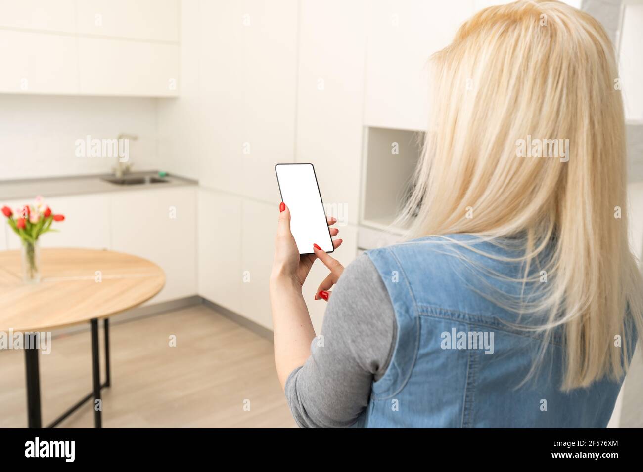 Woman using smartohone in smart house, empty screen Stock Photo - Alamy