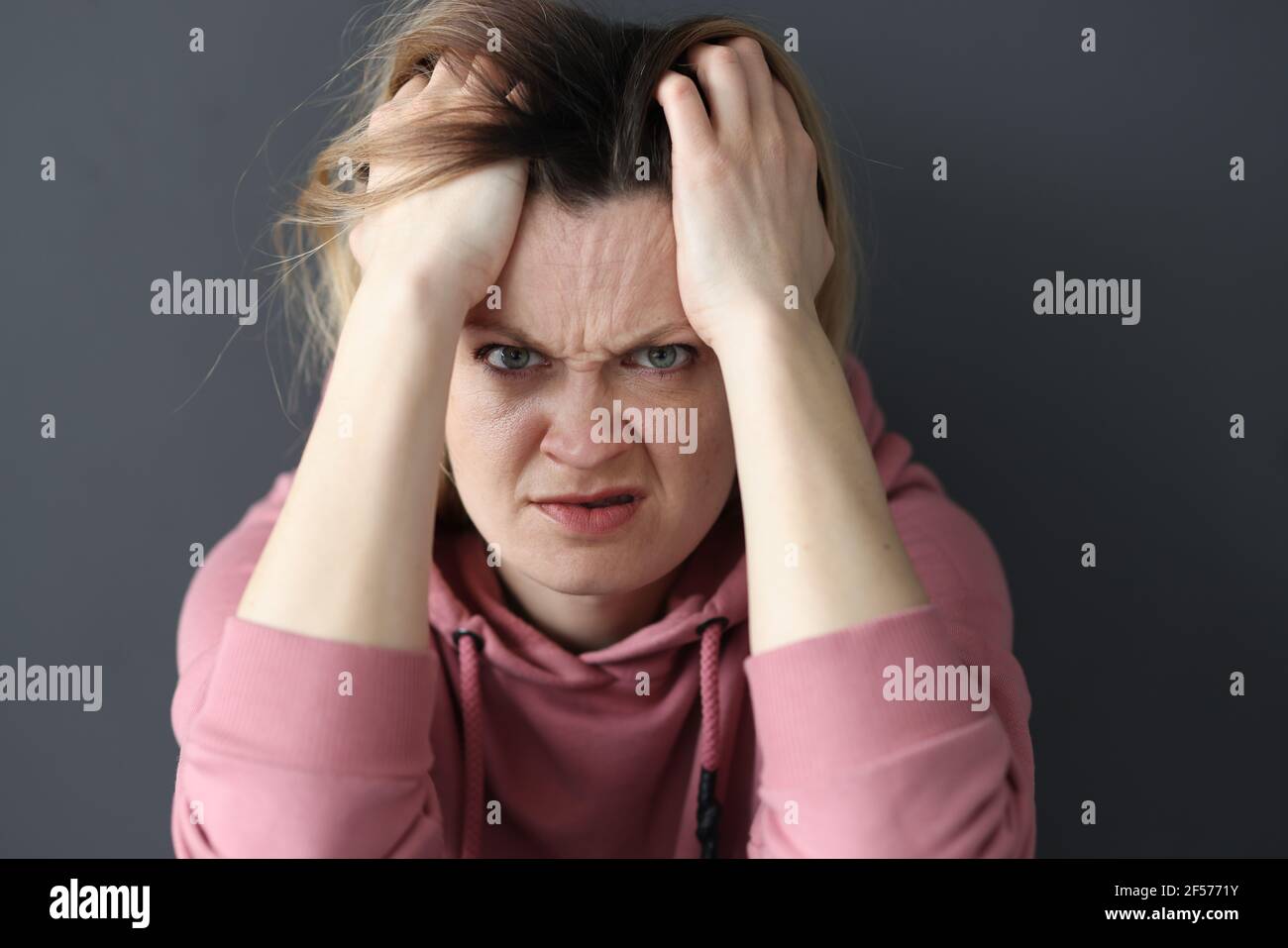Portrait of an angry aggressive woman on gray background Stock Photo ...