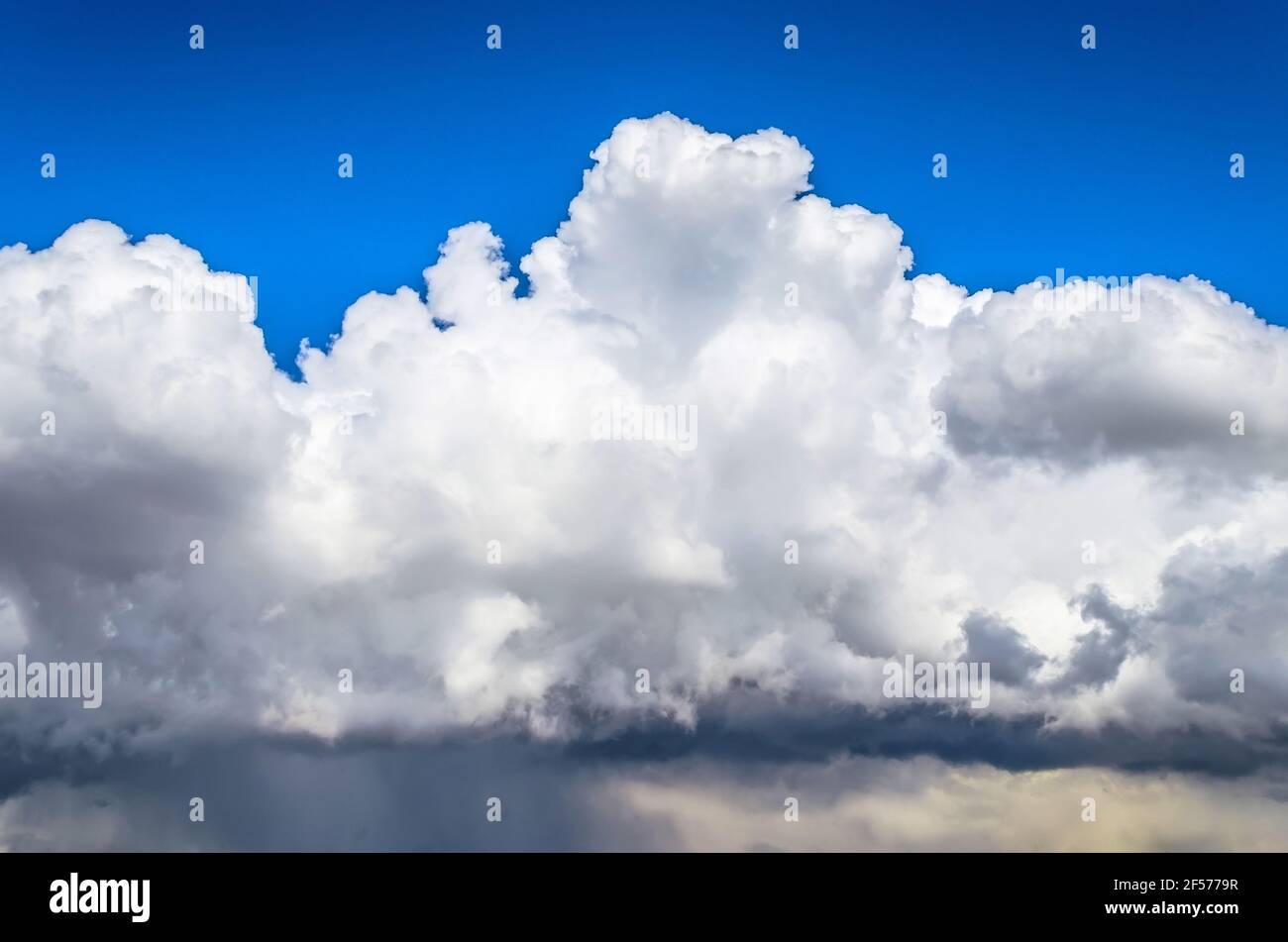 Strong cumulus clouds with falling rain and snow stripes on top of the ...