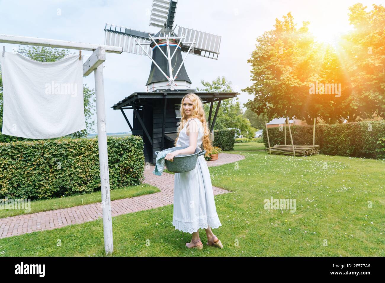 Woman dressed on traditional Dutch dress wooden shoes yellow clogs ...